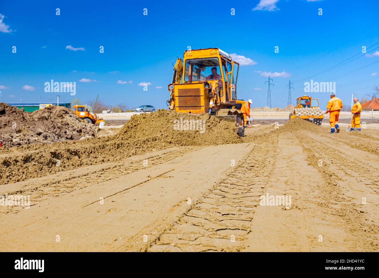 Earthmover with caterpillar is moving earth outdoors Stock Photo - Alamy