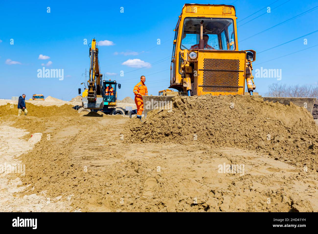 Earthmover with caterpillar is moving earth outdoors Stock Photo - Alamy