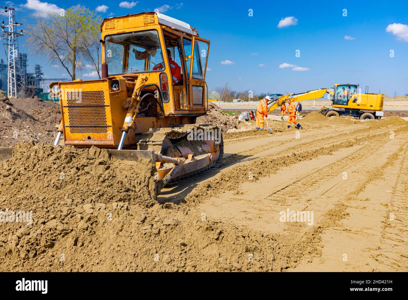 Earthmover with caterpillar is moving earth outdoors Stock Photo - Alamy