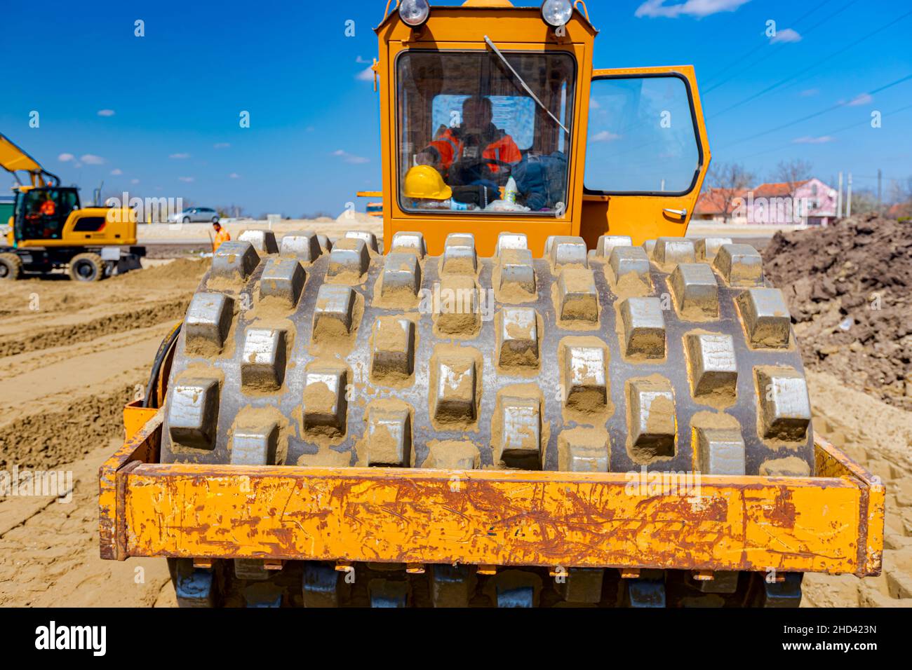 View on road roller with spikes vibrating, compactor is compacting ...
