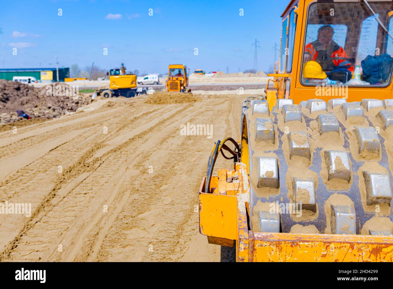 View on road roller with spikes vibrating, compactor is compacting ...