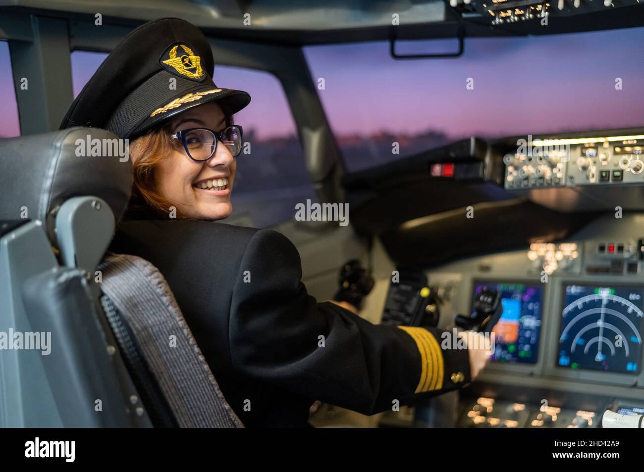 Female pilot on board the aircraft. Caucasian woman in flight simulator ...