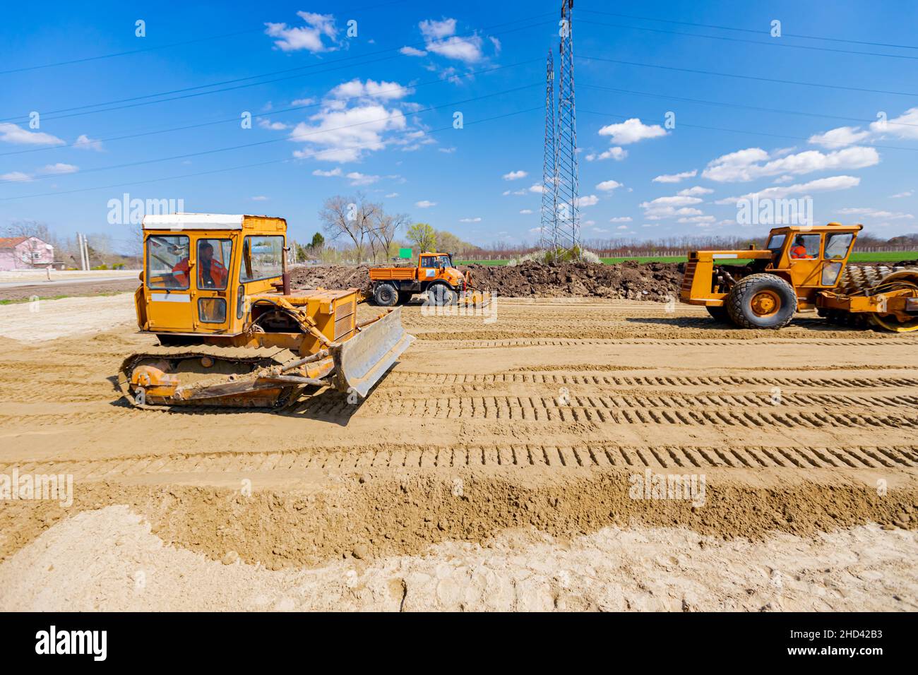 Road roller with spikes, bulldozer and truck with mounted plate ...