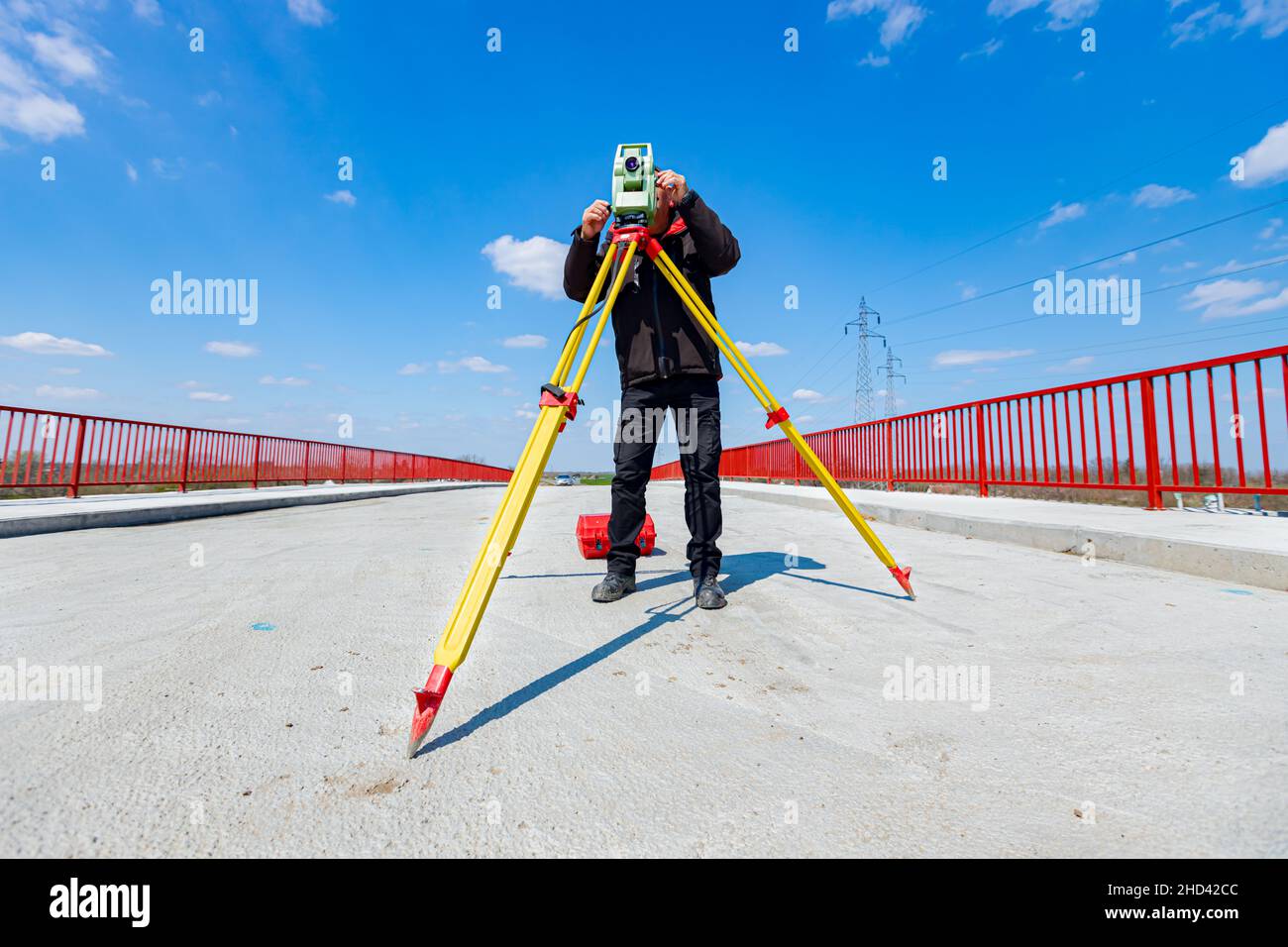 Surveyor engineer is measuring bridge under construction, site ...
