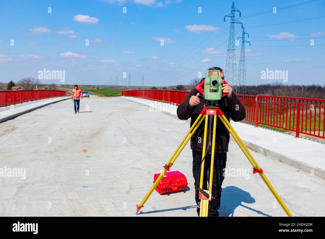 Surveyor engineer is measuring bridge under construction, site ...