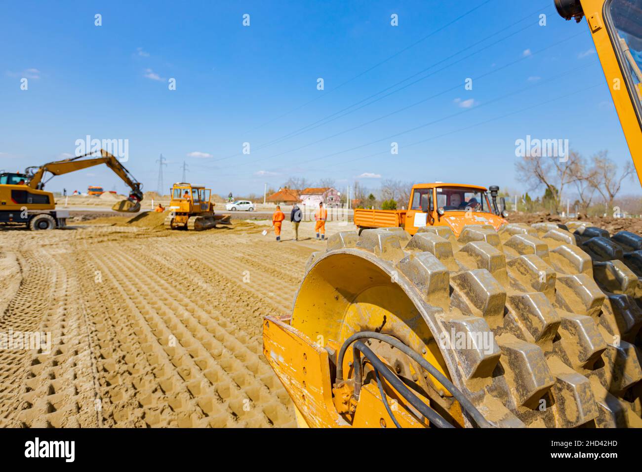 View on road roller with spikes vibrating, compactor is compacting ...
