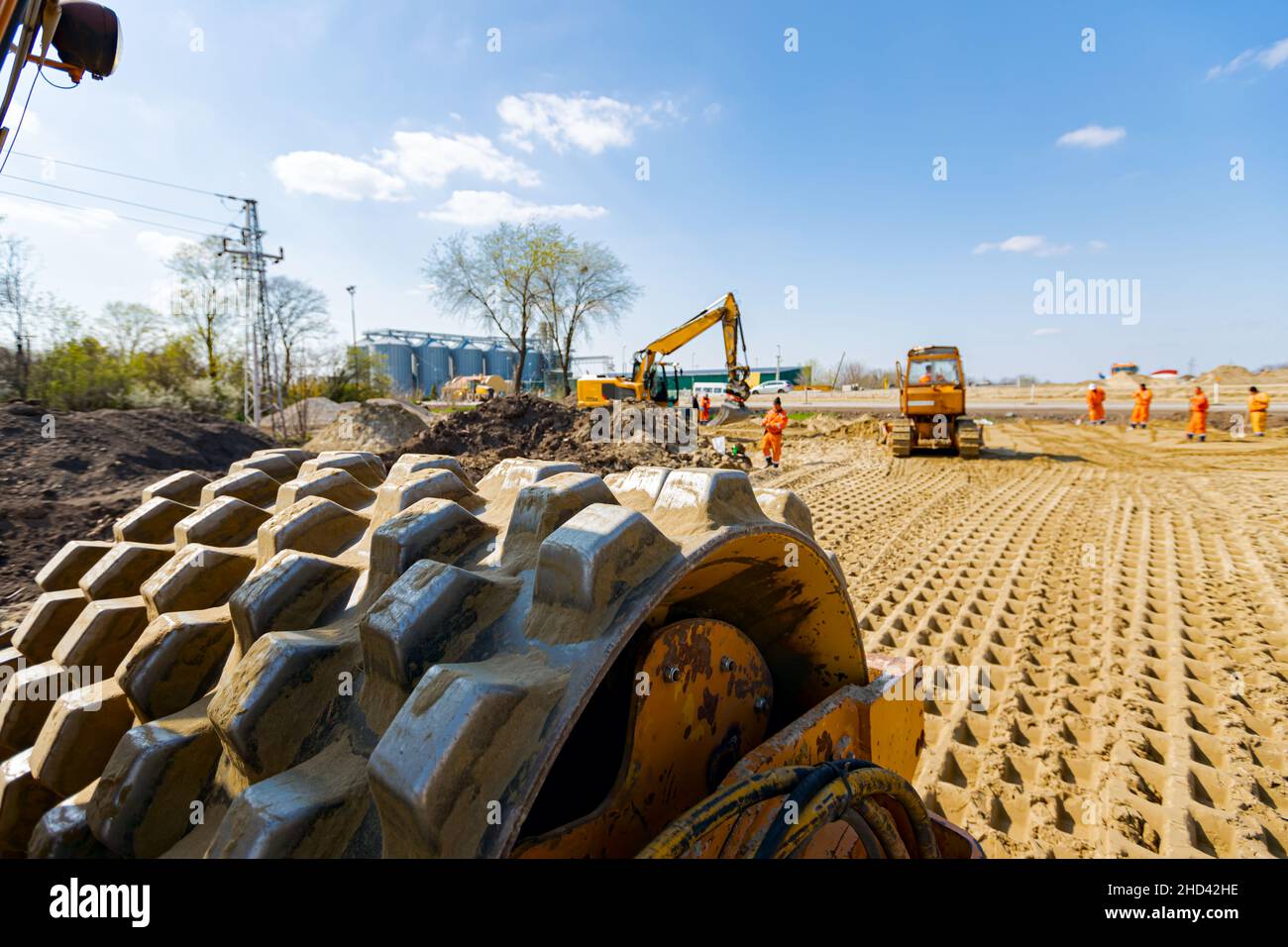 View on road roller with spikes vibrating, compactor is compacting ...