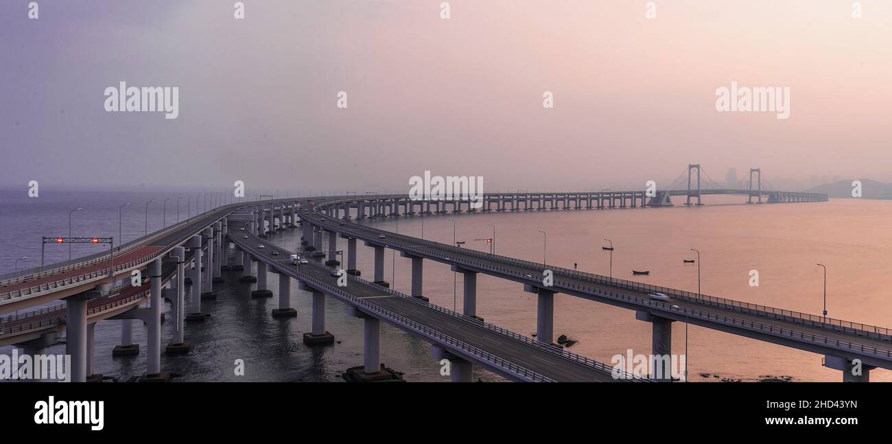 Scenic view of Dalian Xinghai Bay Bridge on a sunset sky background ...