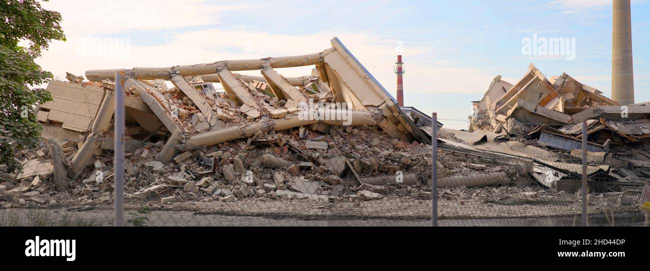 Industrial concrete building behind a fence destructed by strike ...
