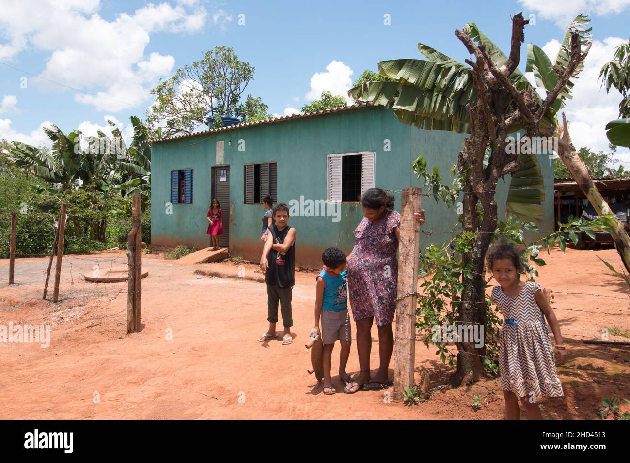 Poor family standing outside their house. Planaltina, Brazil Stock ...