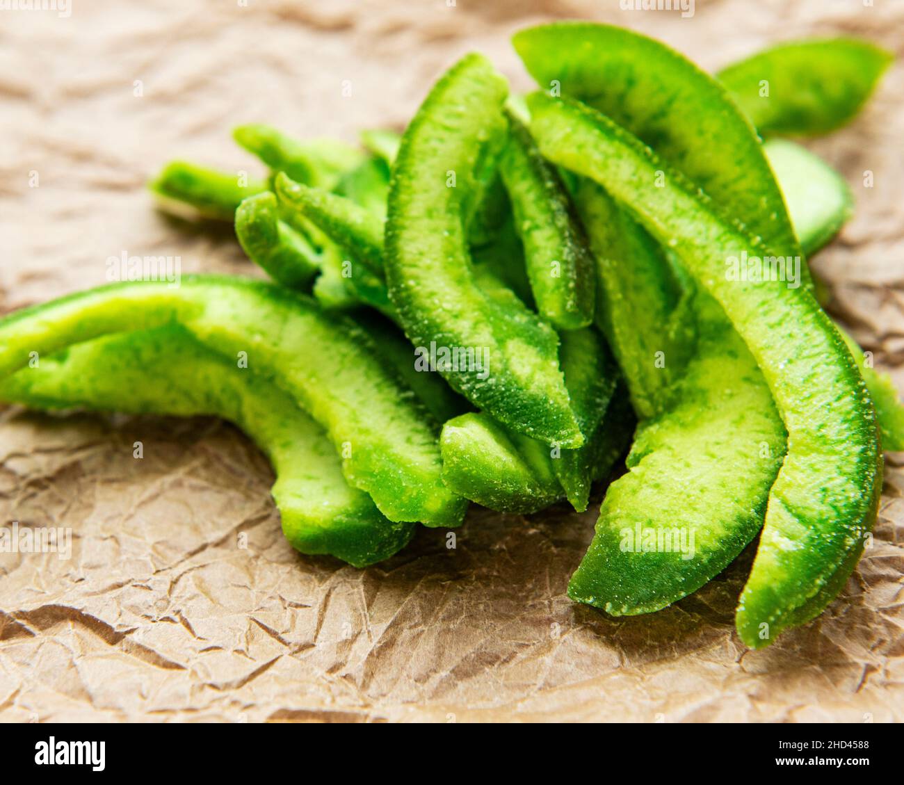 Dry chunks of pomelo on a plate on a brown paper background Stock Photo ...