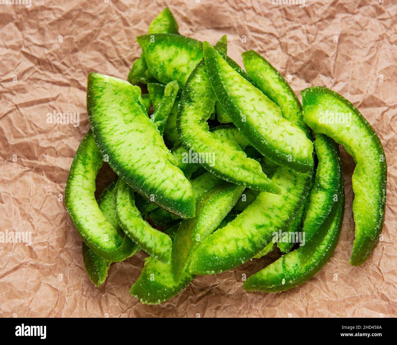 Dry chunks of pomelo on a plate on a brown paper background Stock Photo ...