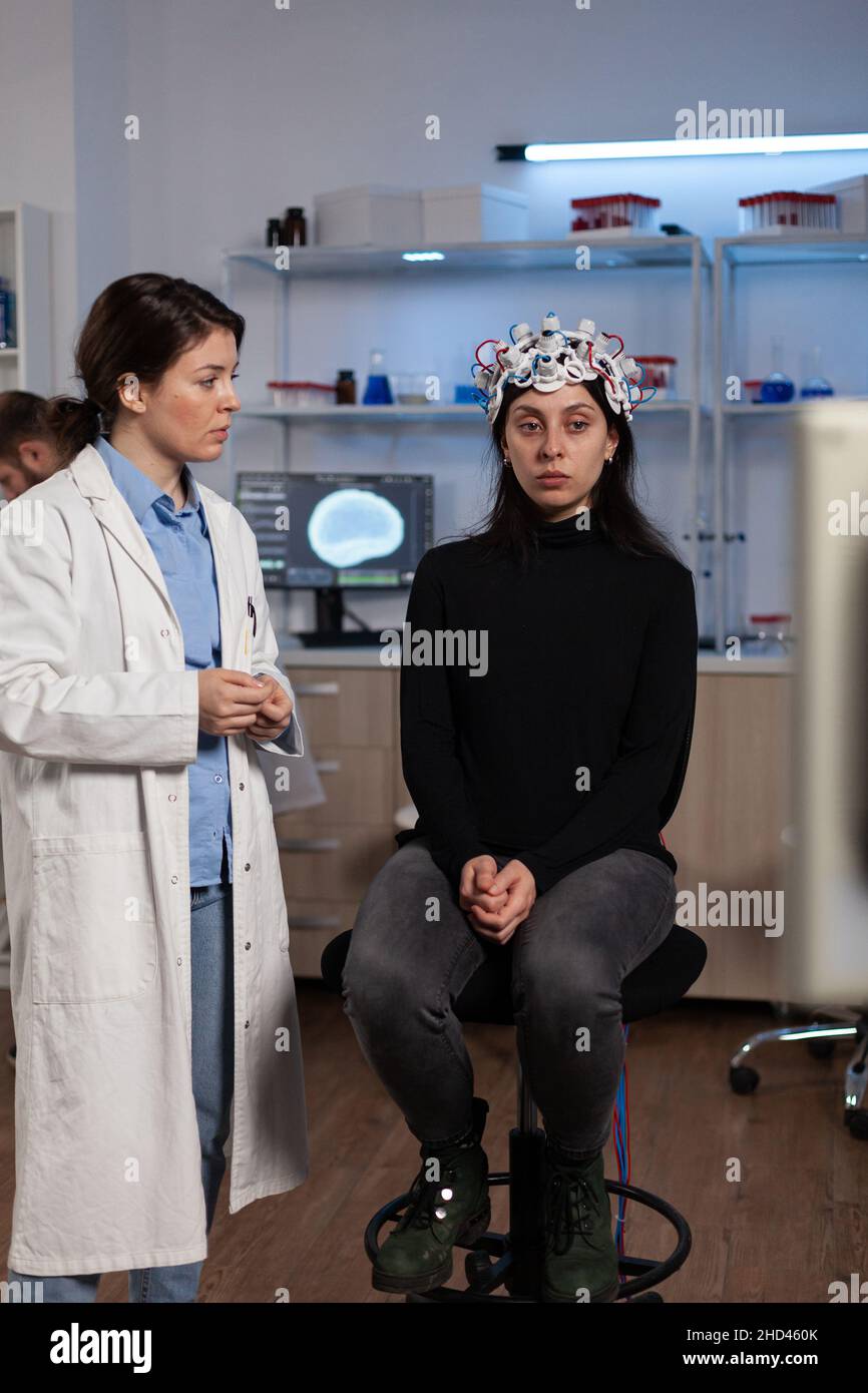 Neurologist doctor showing tomography expertise to woman patient with ...