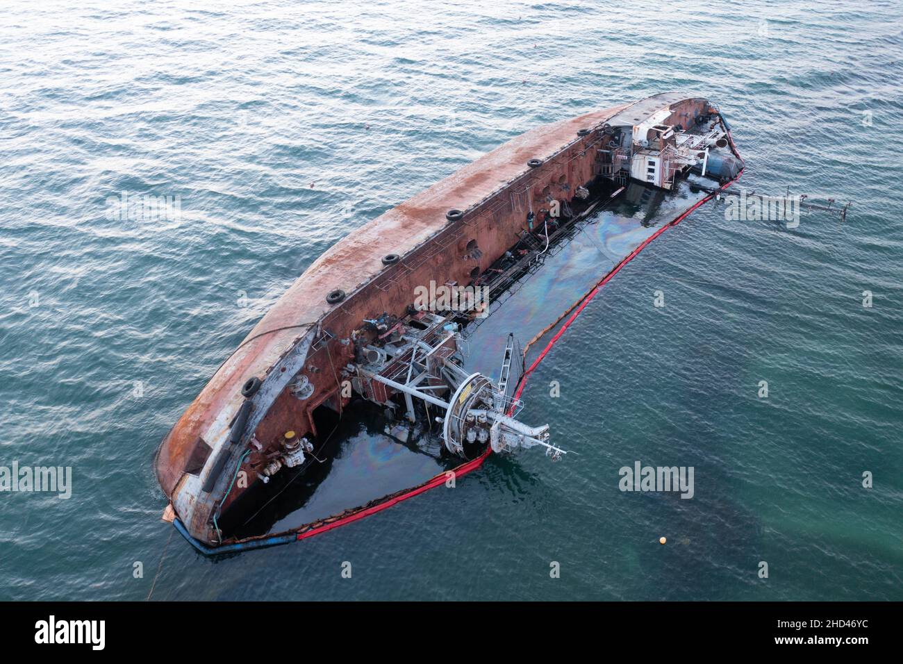 Shipwreck, overturned barge, petroleum products leak into the water ...