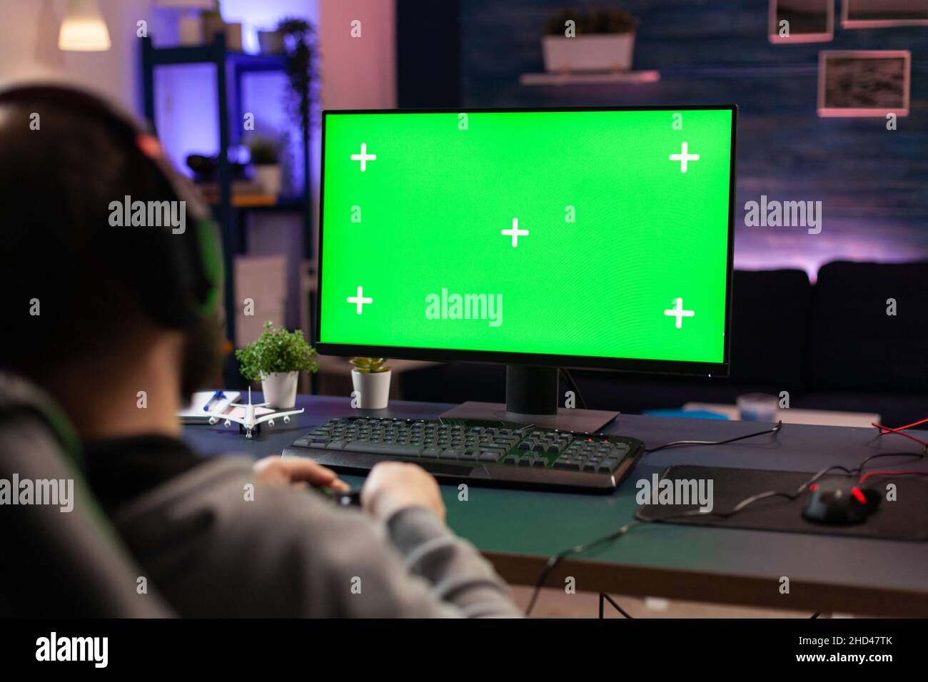 Gamer using horizontal green screen on computer. Man playing video ...