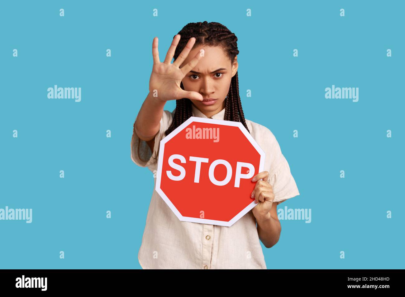 Access denied. Bossy woman with dreadlocks showing stop gesture with ...