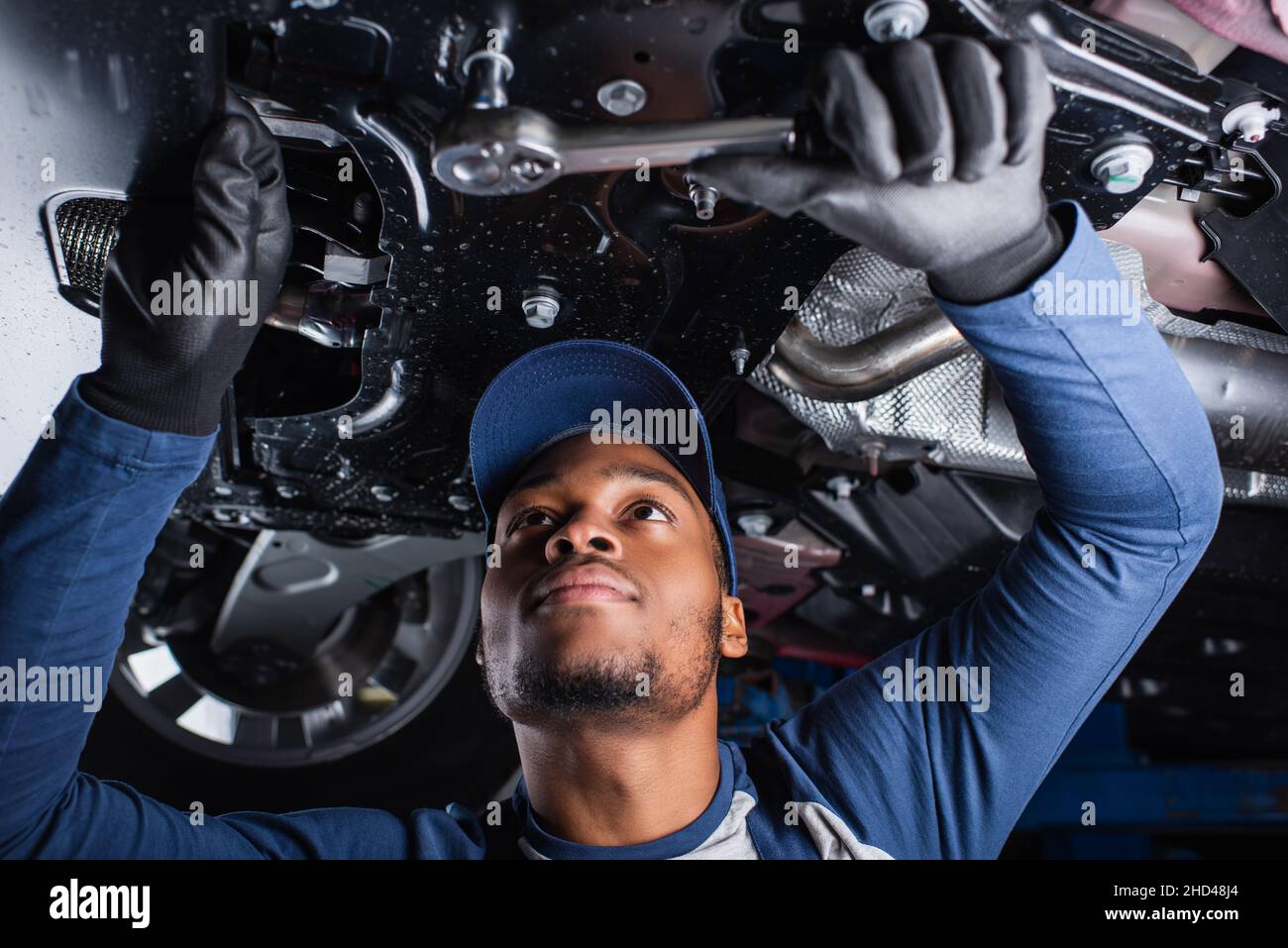 Young mechanic working under car hi-res stock photography and images ...