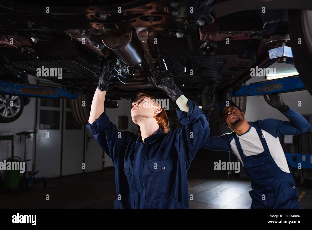 Repairman in uniform inspecting bottom hi-res stock photography and ...