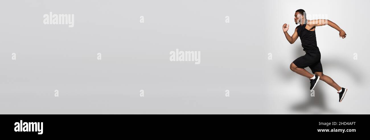 full length of fast african american sportsman levitating while running ...