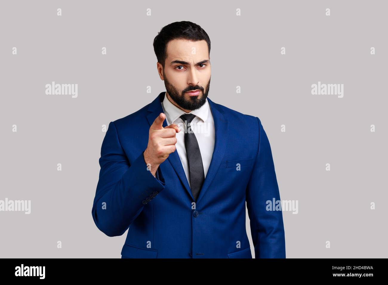 Portrait of serious strict bearded man standing with admonishing ...