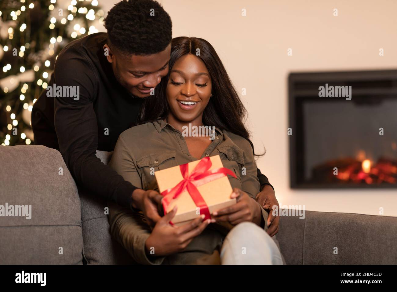 African Husband Giving Valentine Present In Box To Wife Indoor Stock ...
