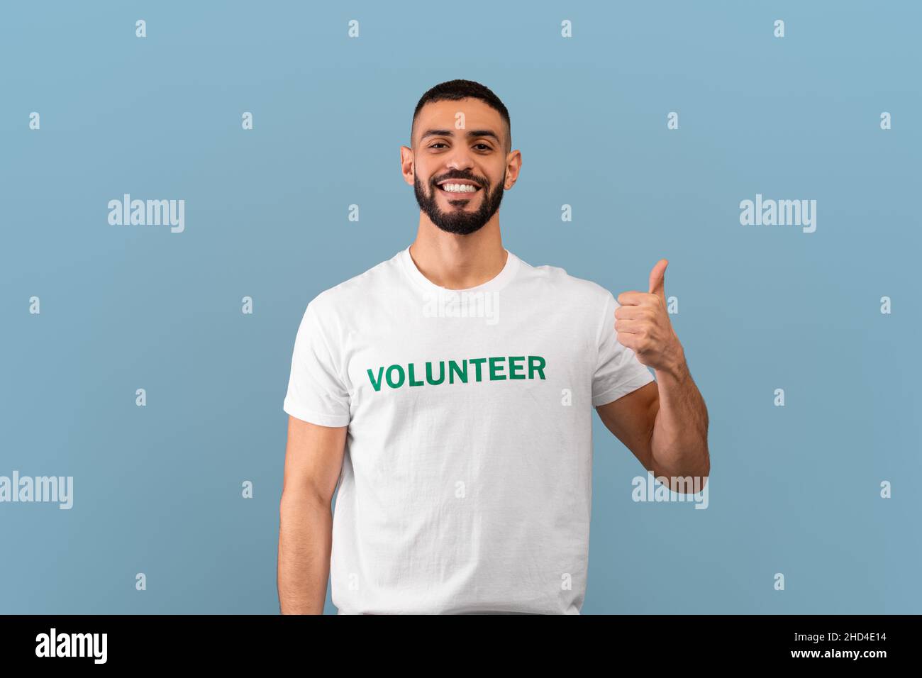 I like volunteering. Portrait of happy middle eastern male activist ...