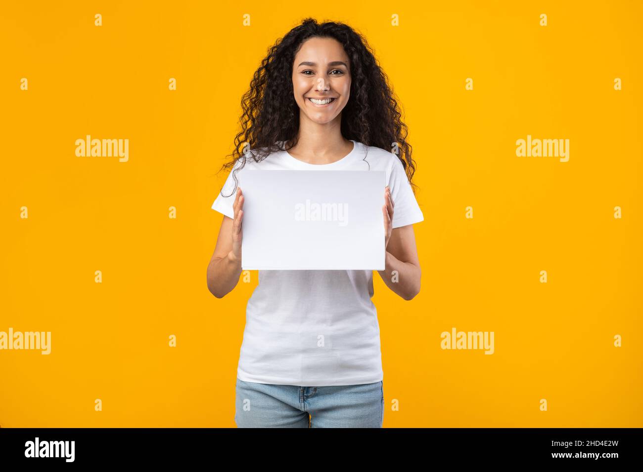 Happy Lady Holding Empty Paper Board Standing Over Yellow Background ...