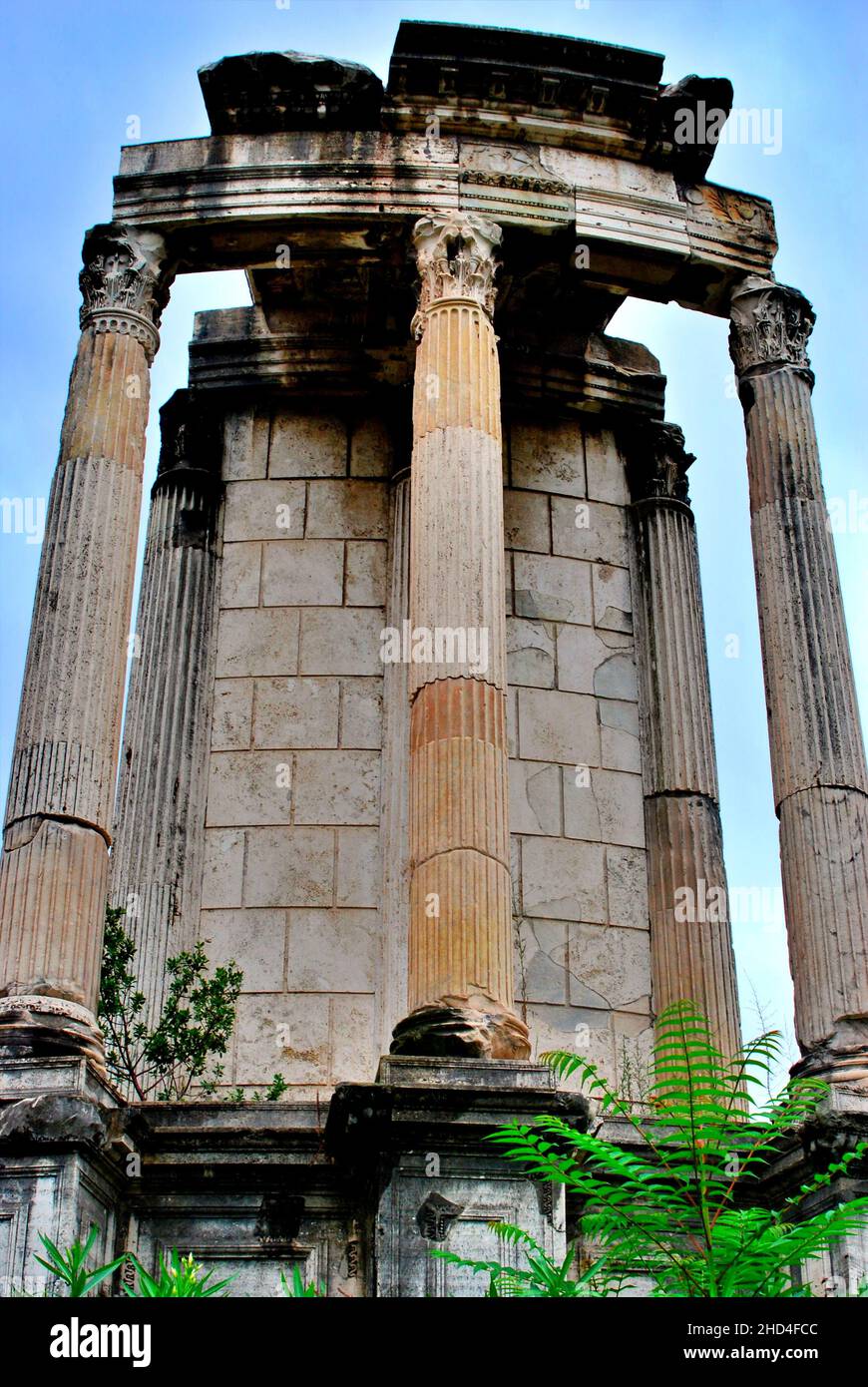 Low angle of a ruined stone ancient columns in Pompeii, Campania, Italy ...