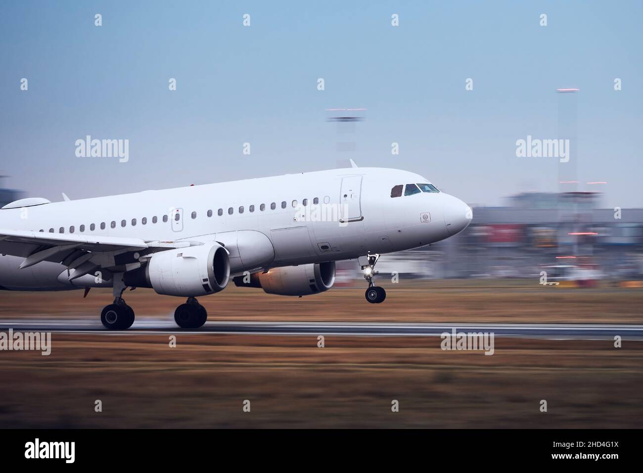 Airplane during landing on airport runway at night. Plane in blurred ...