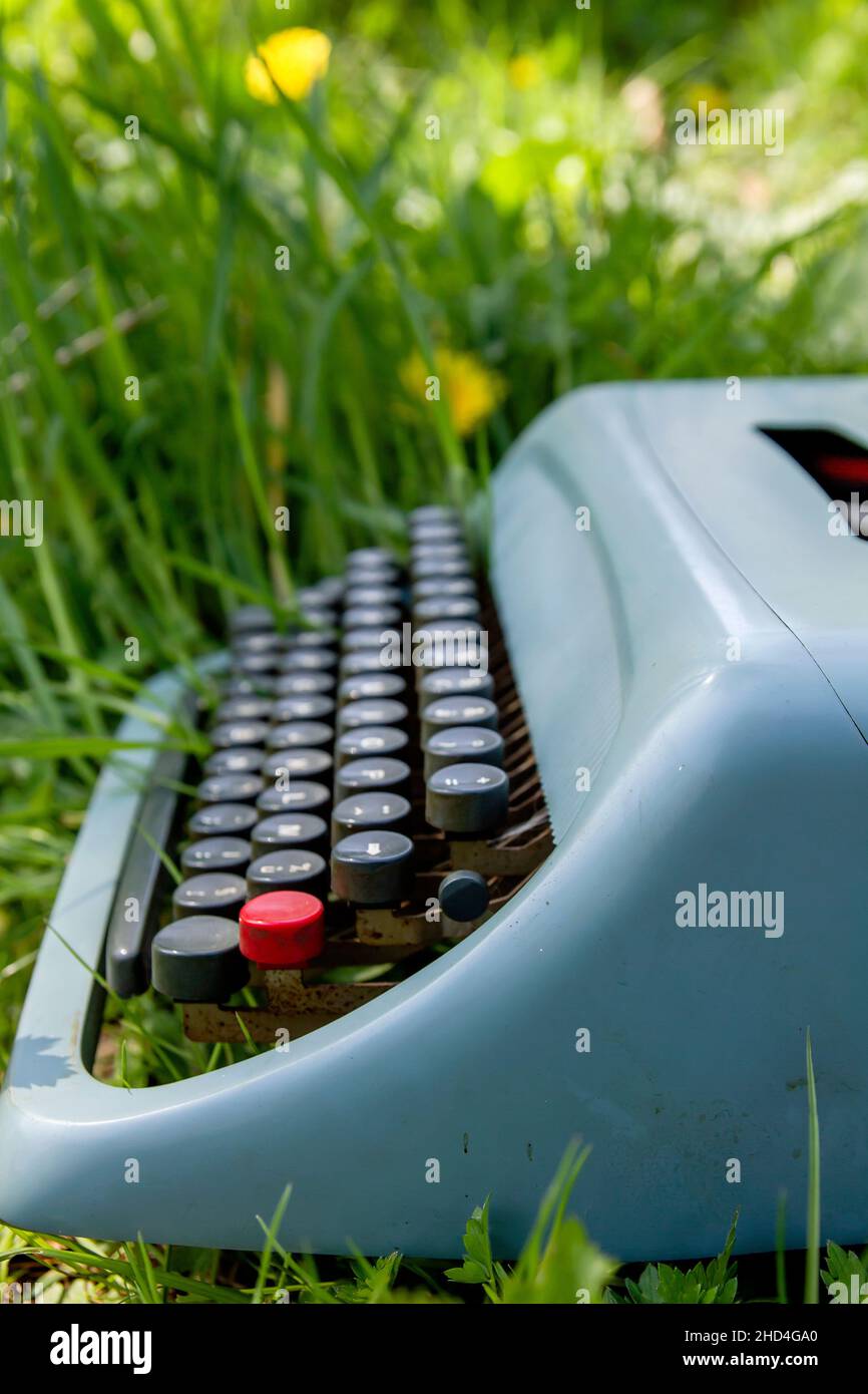 Old vintage blue typewriter on the green garden grass Stock Photo - Alamy