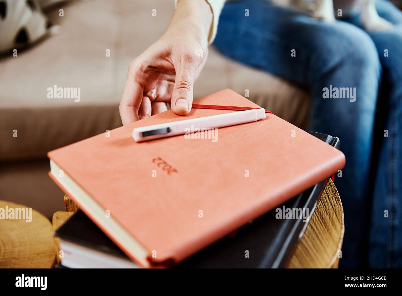 Female hand take notebook form table. Woman works at home Stock Photo ...