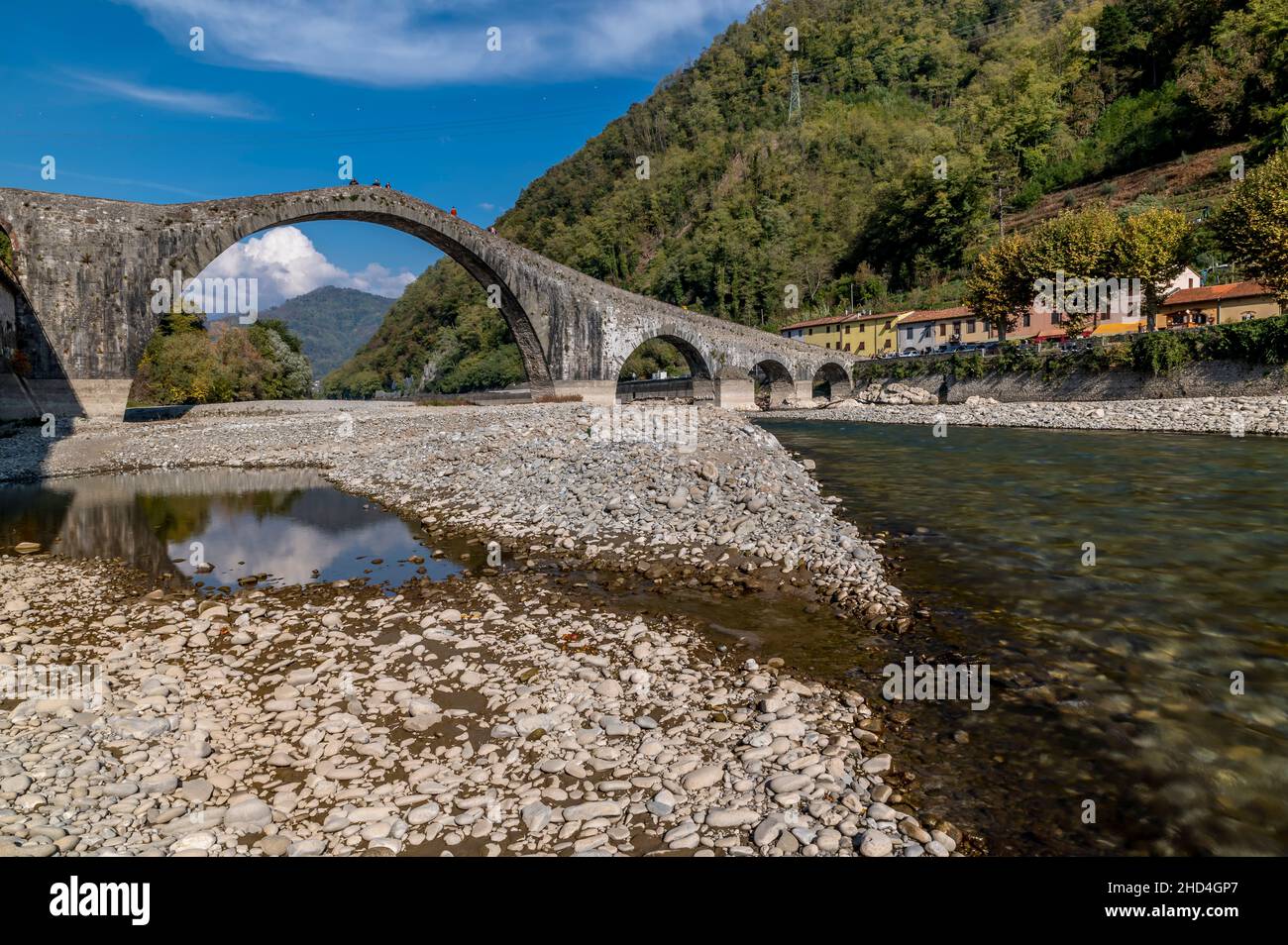 The Serchio River flows under the ancient Ponte della Maddalena, Borgo ...