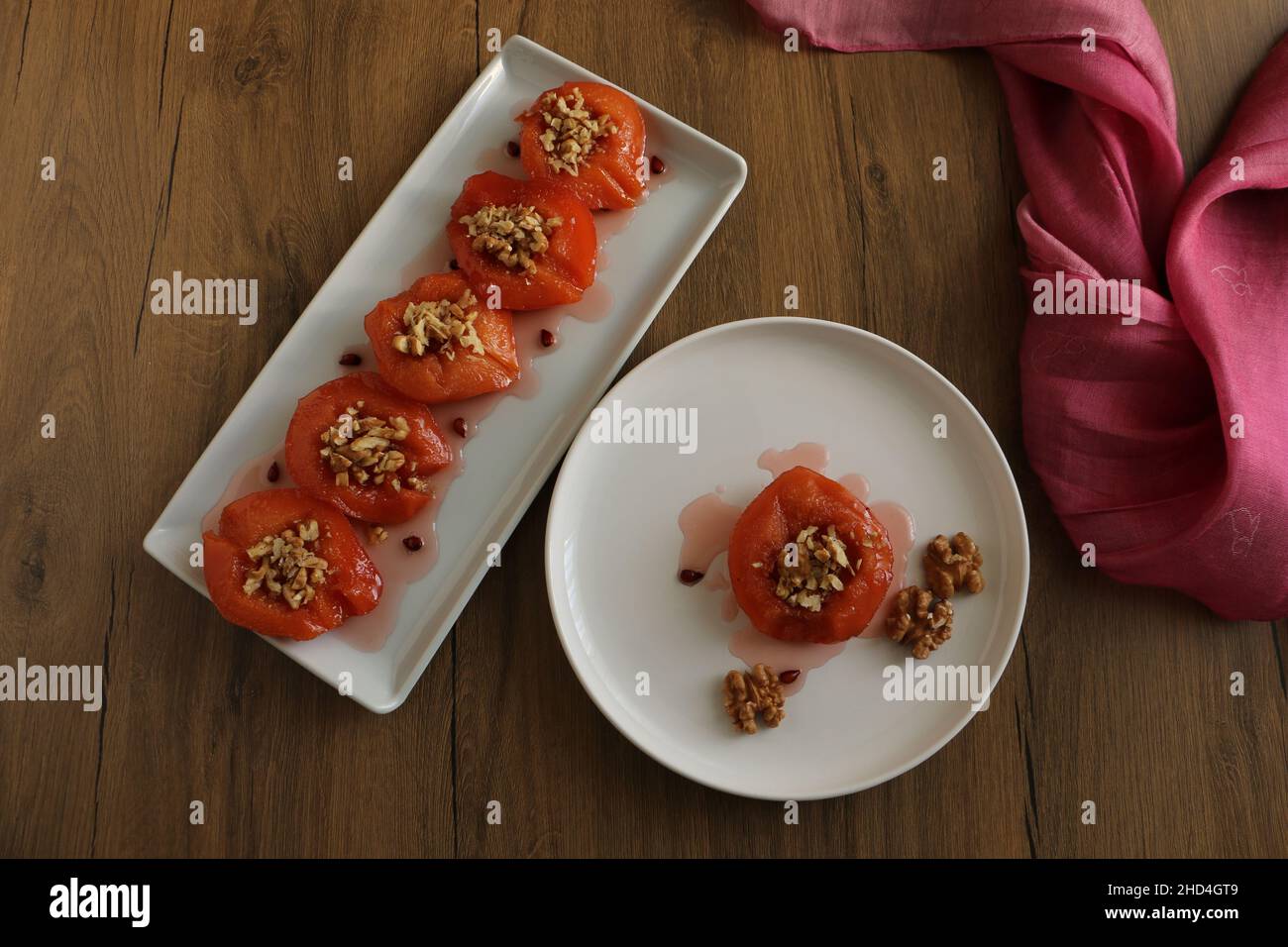 Quince dessert, oven baked quince in thick syrup. White plate and ...