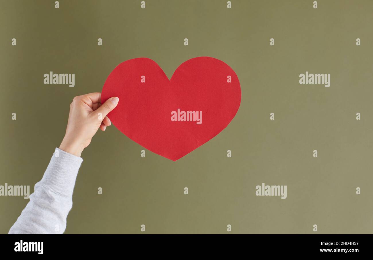 Person hold red heart sign show love Stock Photo - Alamy