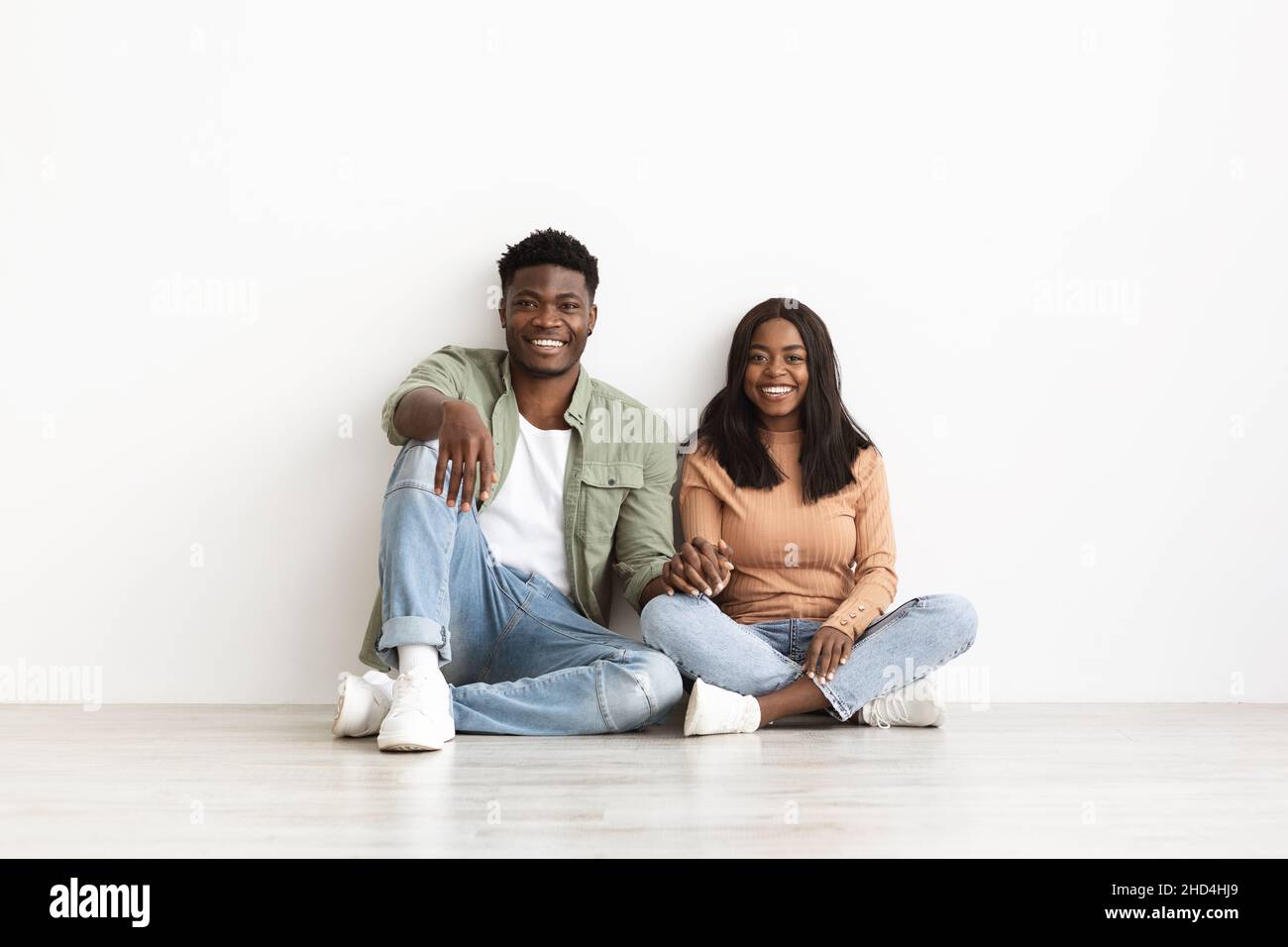 Happy black lady bonding with her happy boyfriend, white background ...