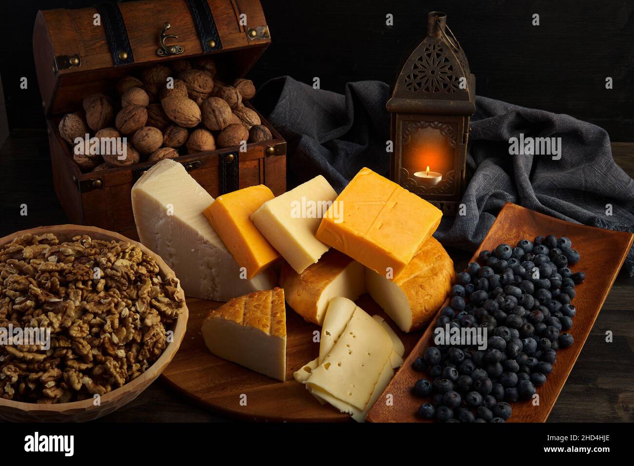 Variety of mature and creamy cheeses on a vintage wooden board Stock ...