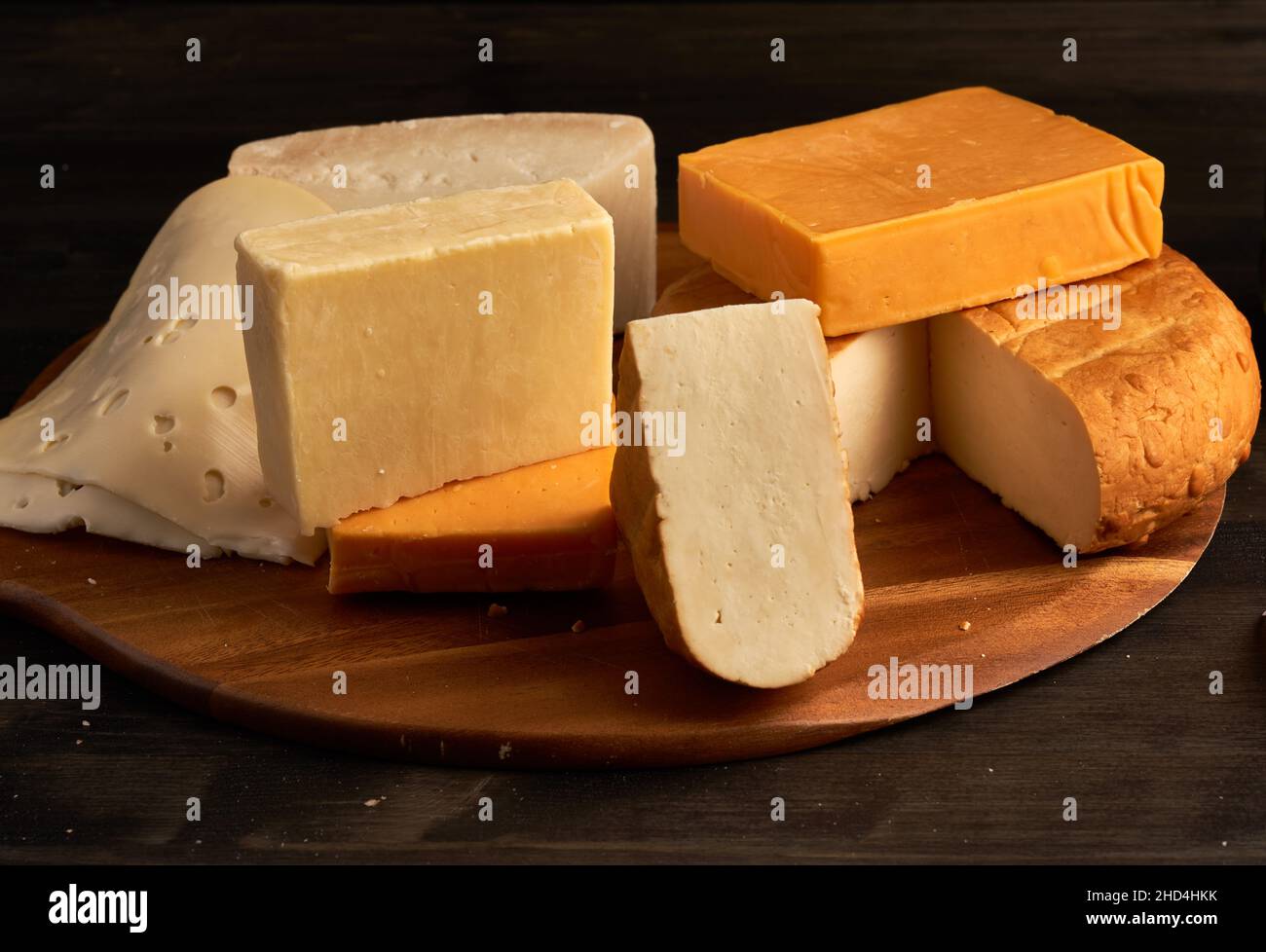 Variety of mature and creamy cheeses on a vintage wooden board Stock ...