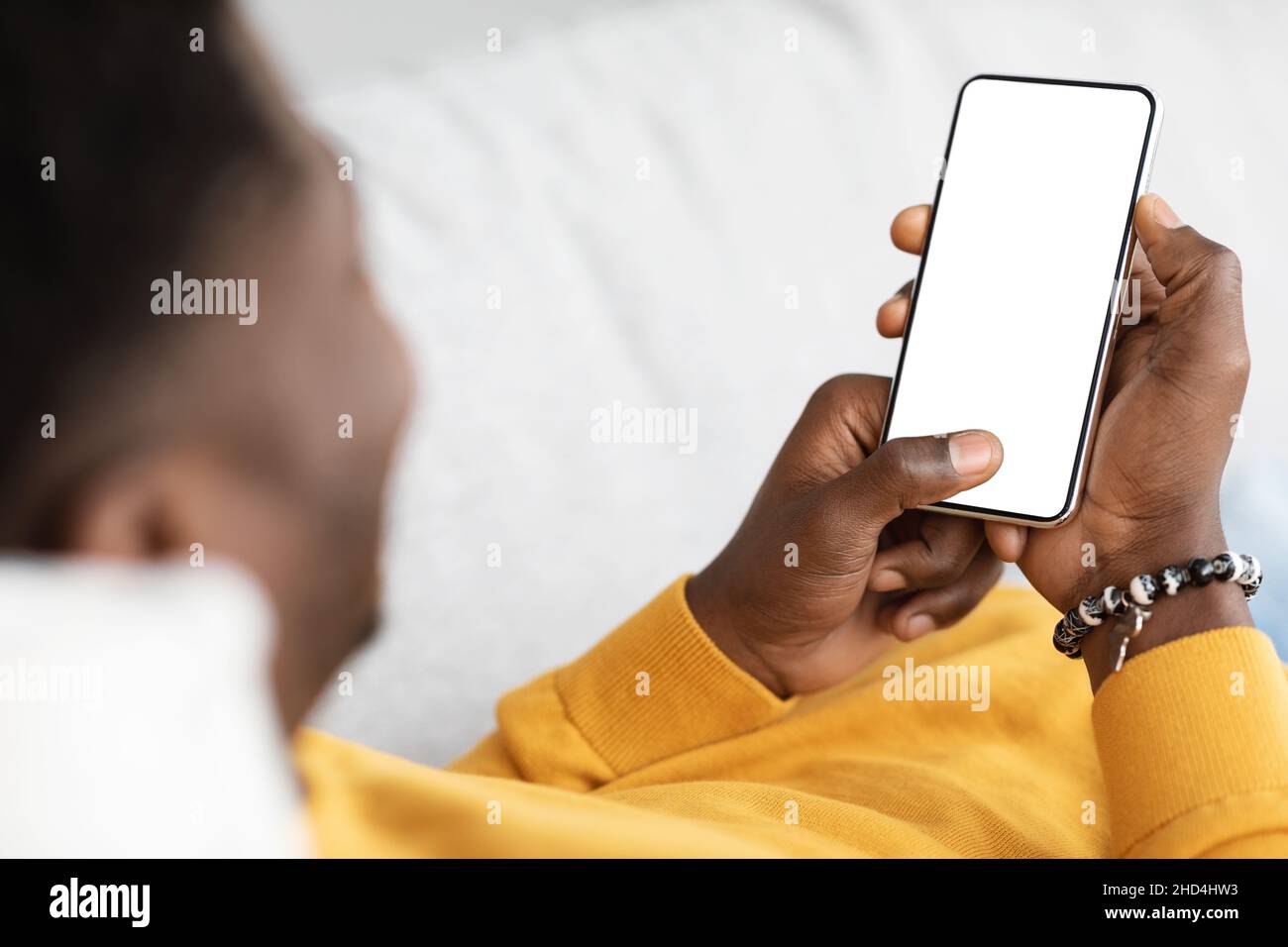 Unrecognizable black guy using mobile phone with empty screen Stock ...
