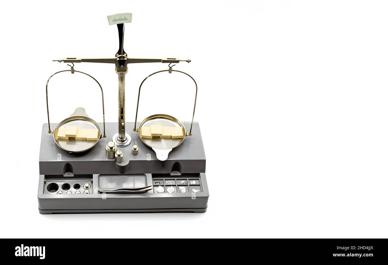 an analog precision balance on whose pans there are blank counters to ...