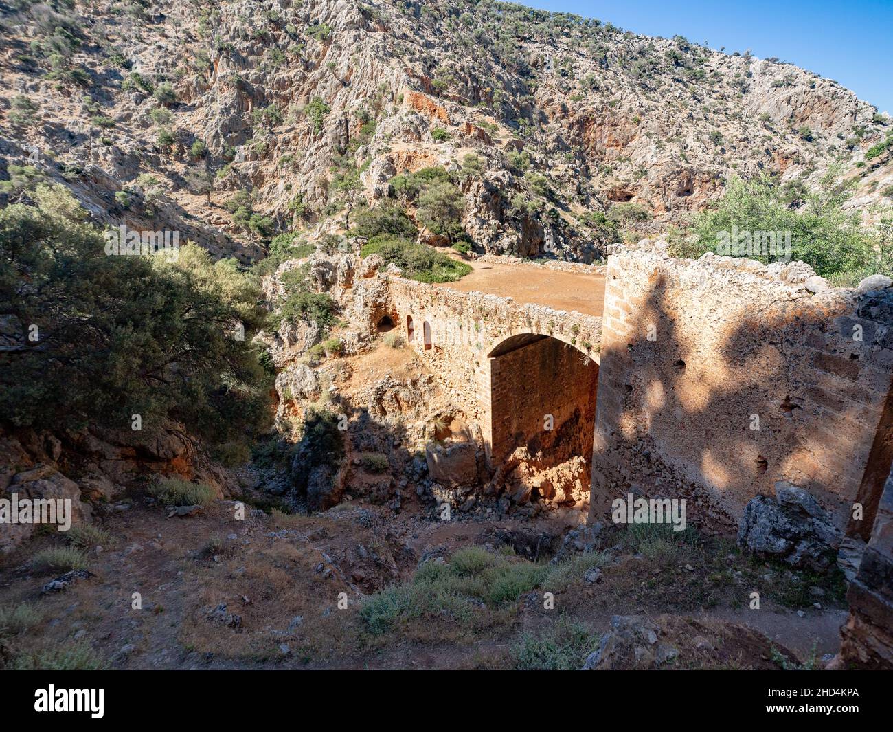 View of an arch and the abandoned Katholiko monastery building in ...