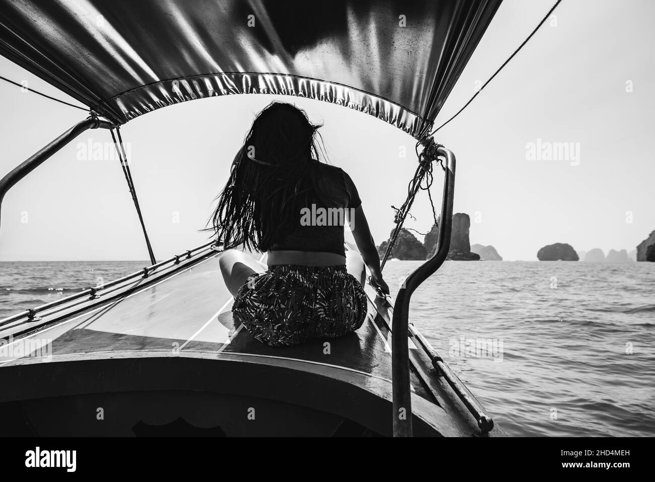 Woman riding a speedboat in the sea; visiting Ao Phang Nga National ...