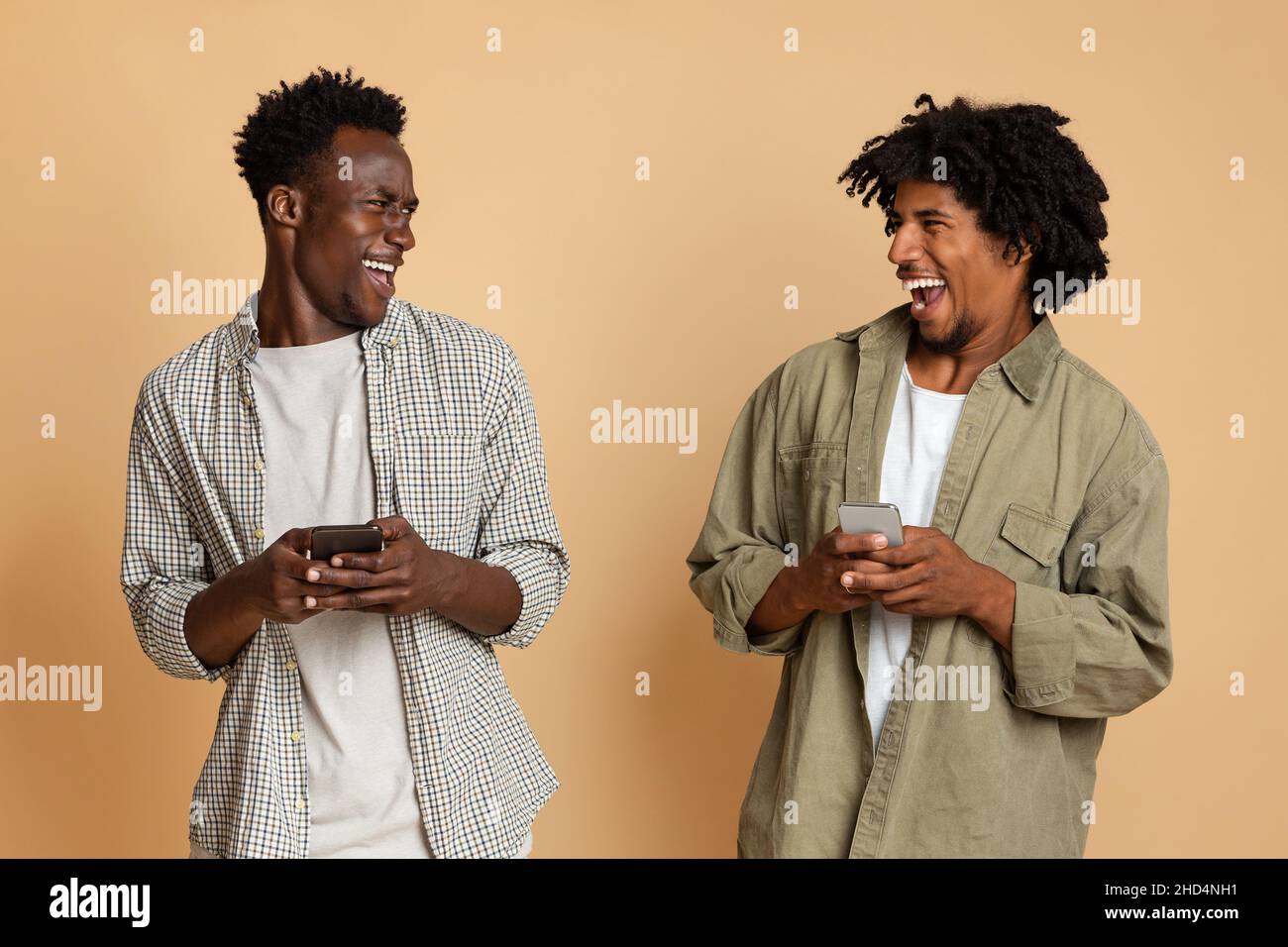 Mobile Gaming. Two Black Friends With Smartphones Playing Online Games ...