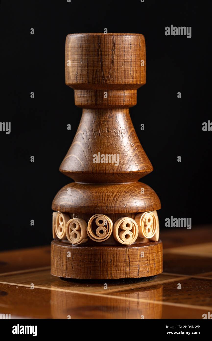 Chess piece of wood black rook. A puzzle game with tricky combinations ...