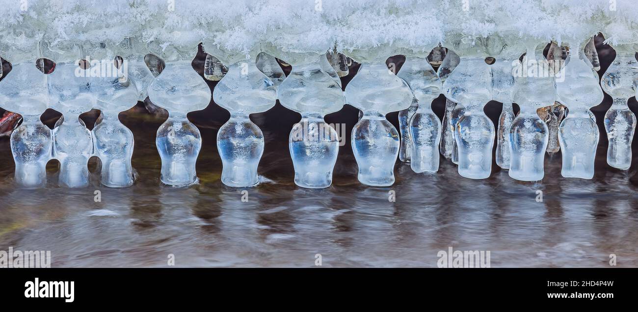 Icicles over the water in the river. Natural landscape. Winter ...