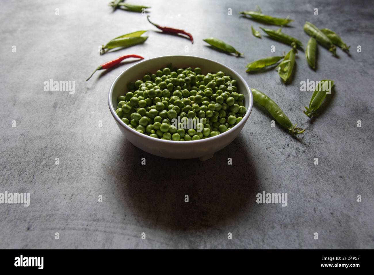 Top view of green peas in a white bowl on a background Stock Photo - Alamy