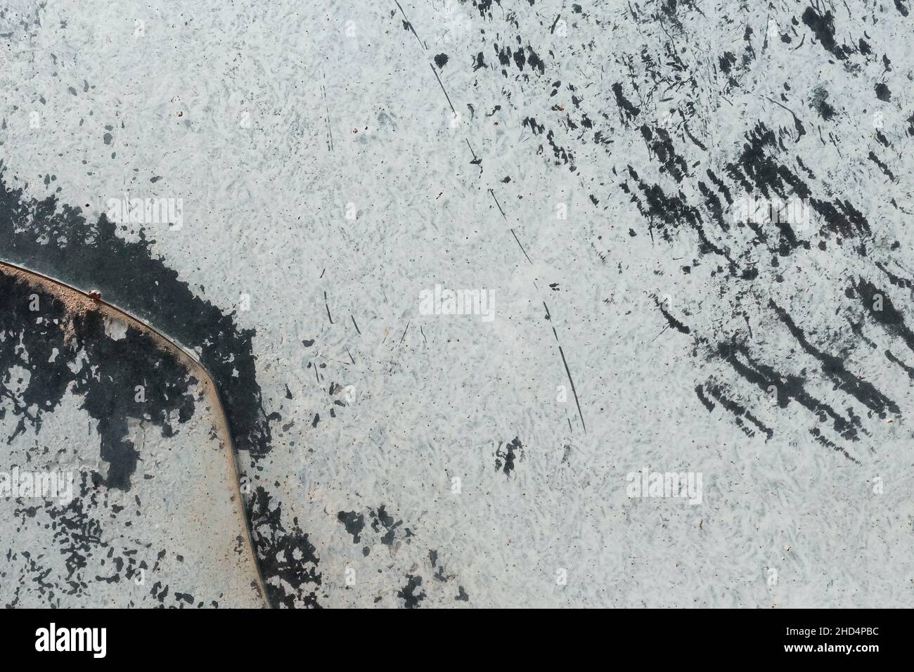 Chipped white paint on broken scratched glass. Abstract background with ...