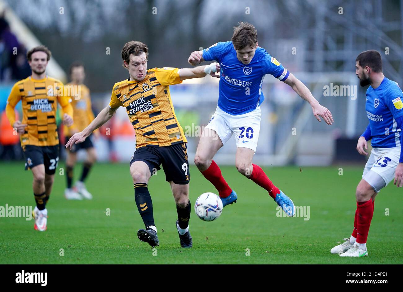 Cambridge United's Joe Ironside (left) and Portsmouth's Sean Raggett ...