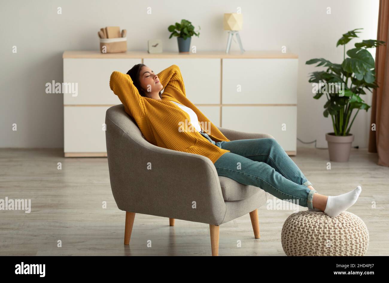 Woman sitting relaxed in armchair hi-res stock photography and images ...