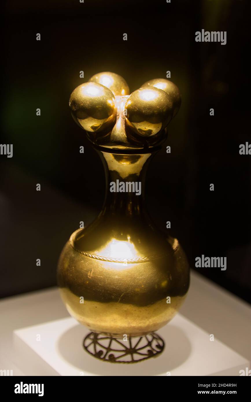 Vertical shot of a poporo quimbaya on display in Gold Museum in the ...