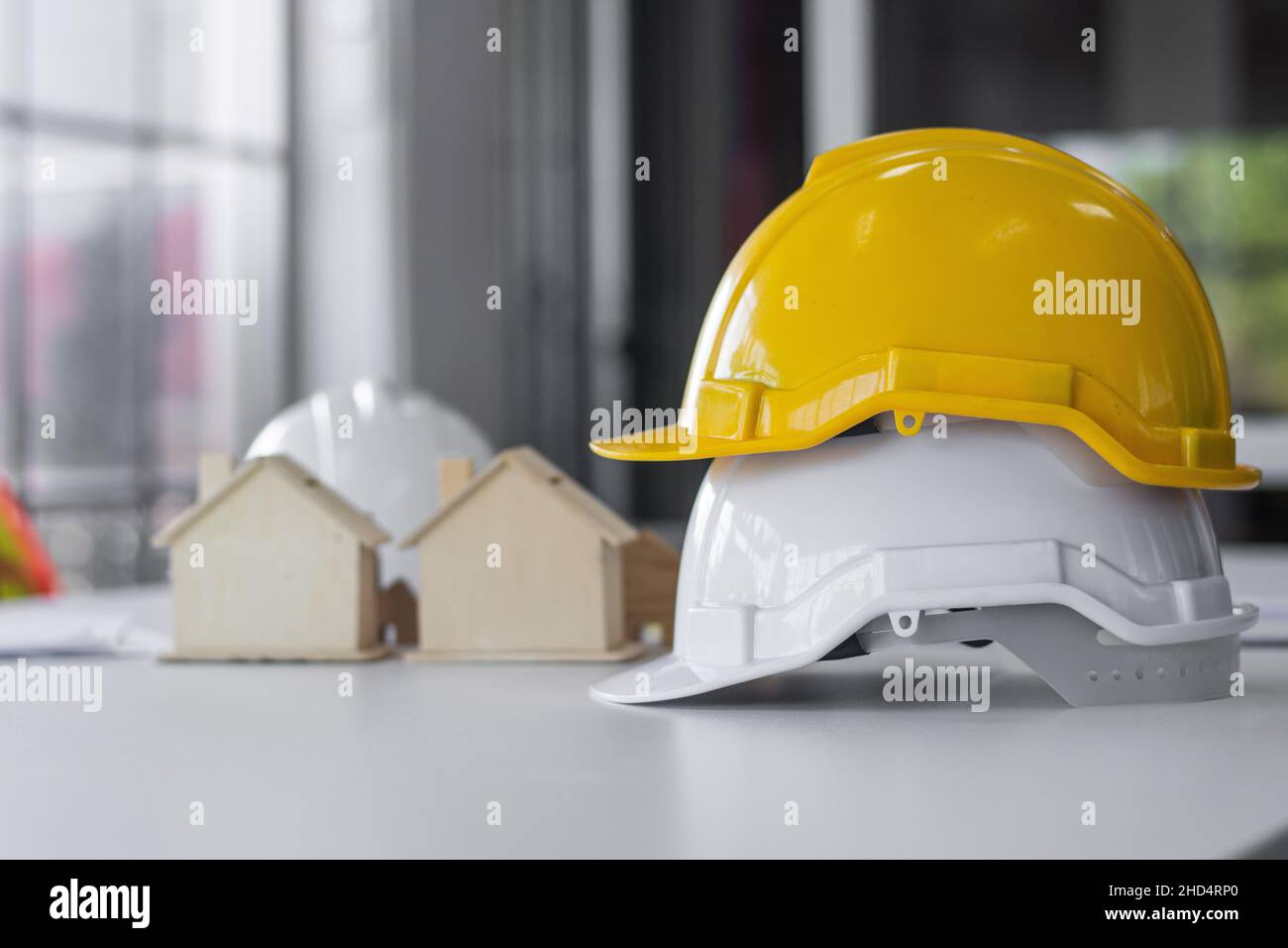 Yellow hard hat on desk work spec for engineering design , Safety ...